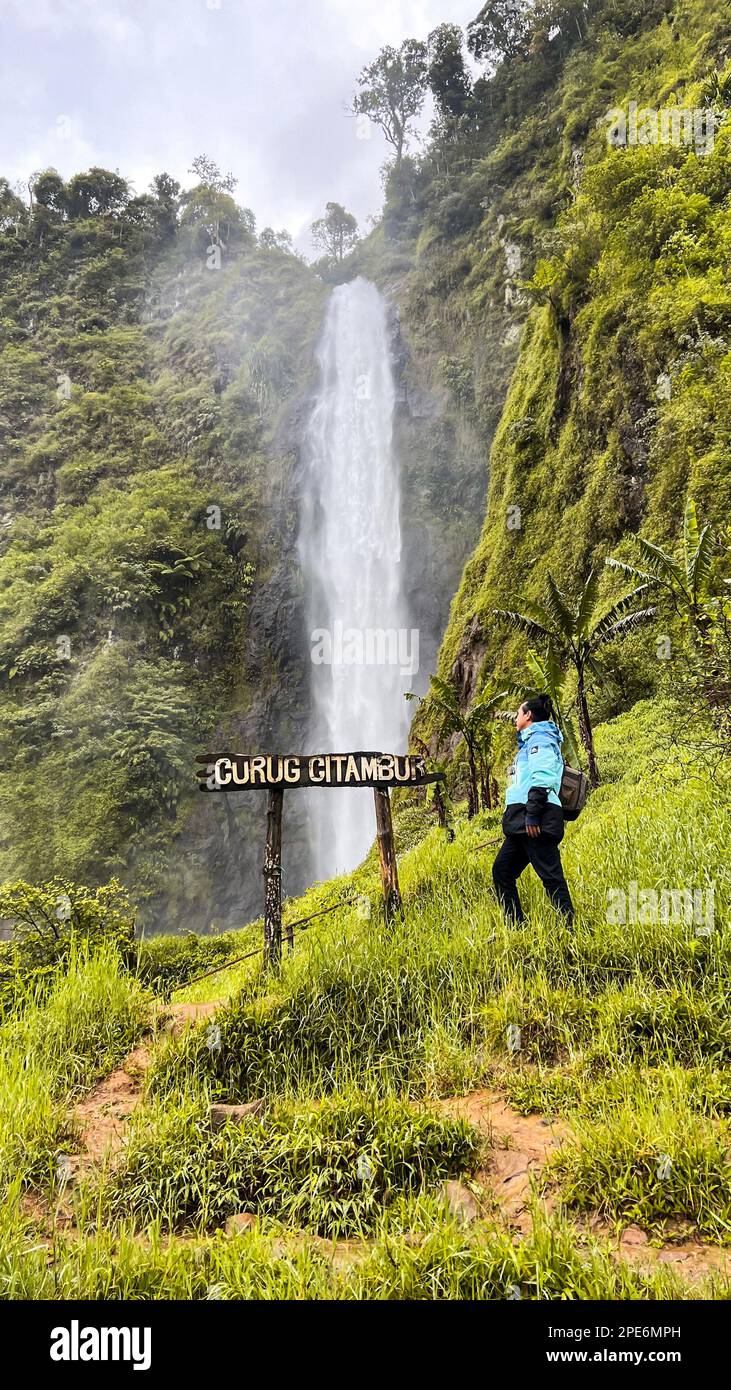 Citambur waterfall. Photo of brave man who proudly standing in front of ...