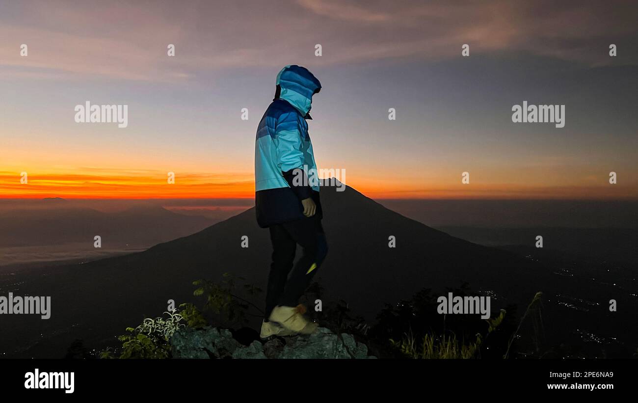 The Man greets the sunrise in the mountains. A man greet the dawn. West ...