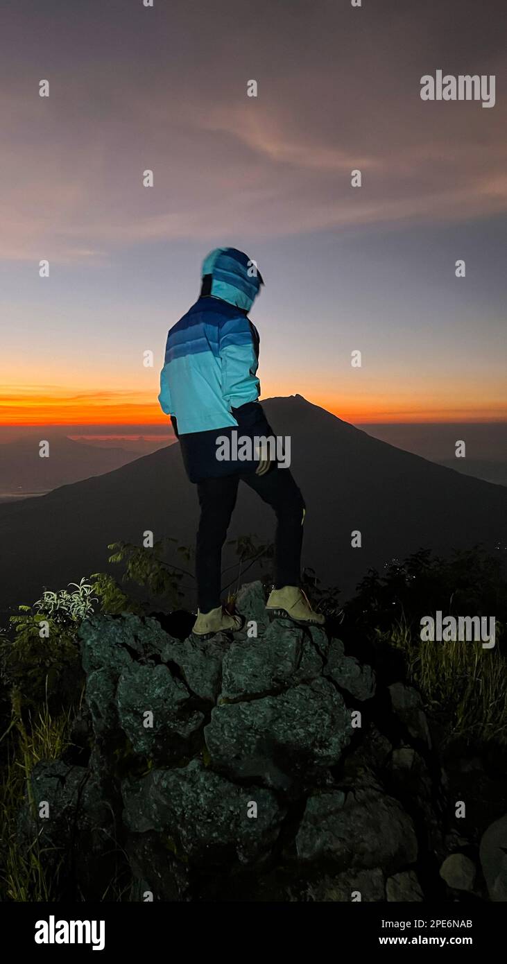 The Man greets the sunrise in the mountains. A man greet the dawn. West ...