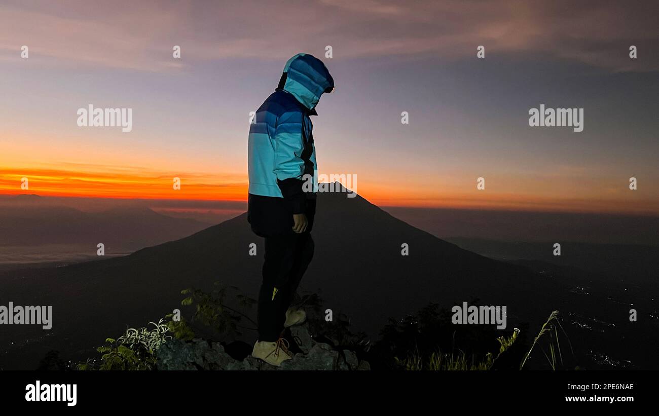 The Man greets the sunrise in the mountains. A man greet the dawn. West ...