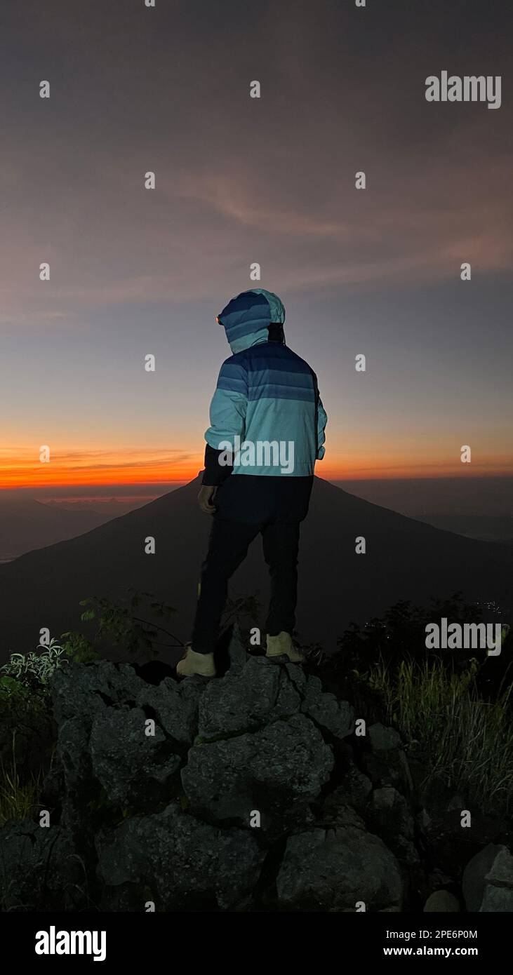 The Man greets the sunrise in the mountains. A man greet the dawn. West ...