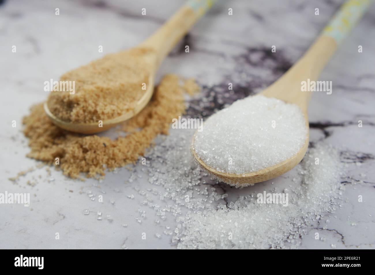 comparing white and brown sugar on table Stock Photo - Alamy