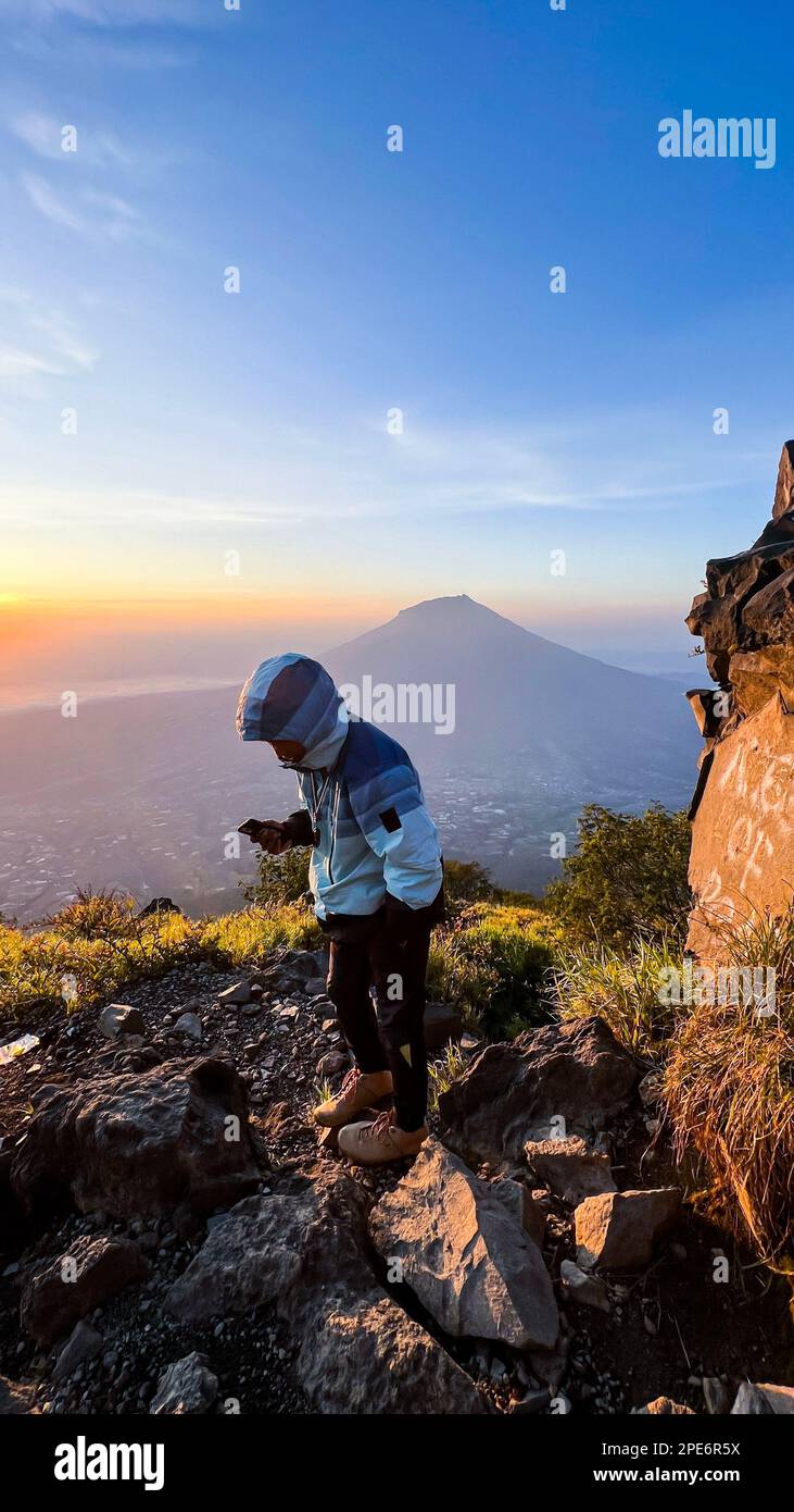 The Man greets the sunrise in the mountains. A man greet the dawn. West ...