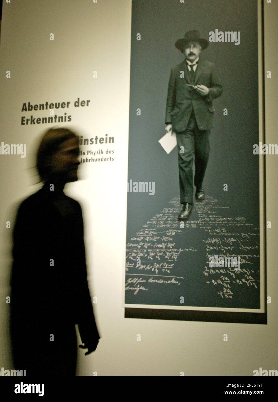A visitor walks past a historical picture of Einstein at the temporary ...
