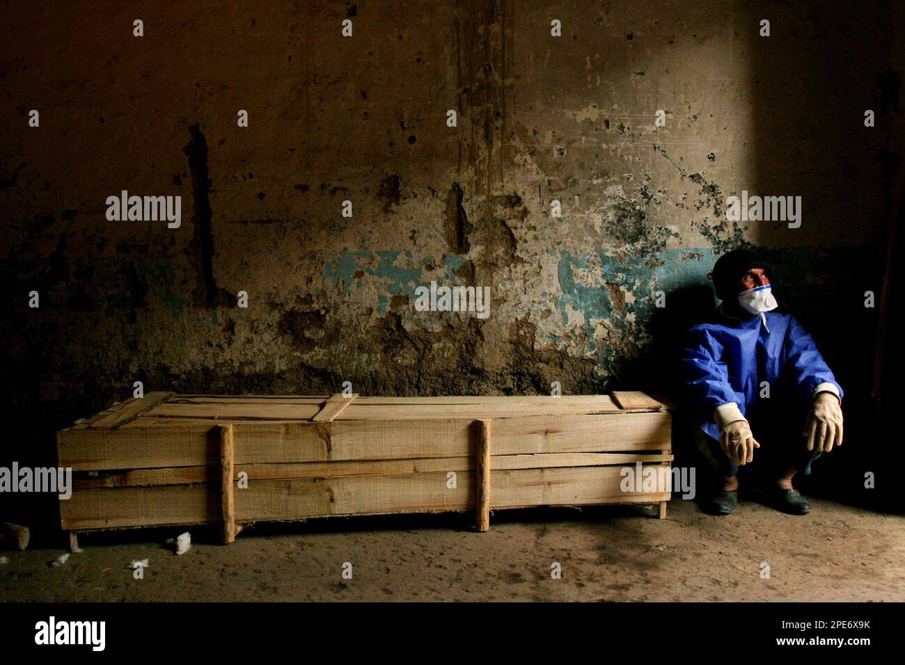 A worker from the morgue of the military hospital of Kabul, takes a ...