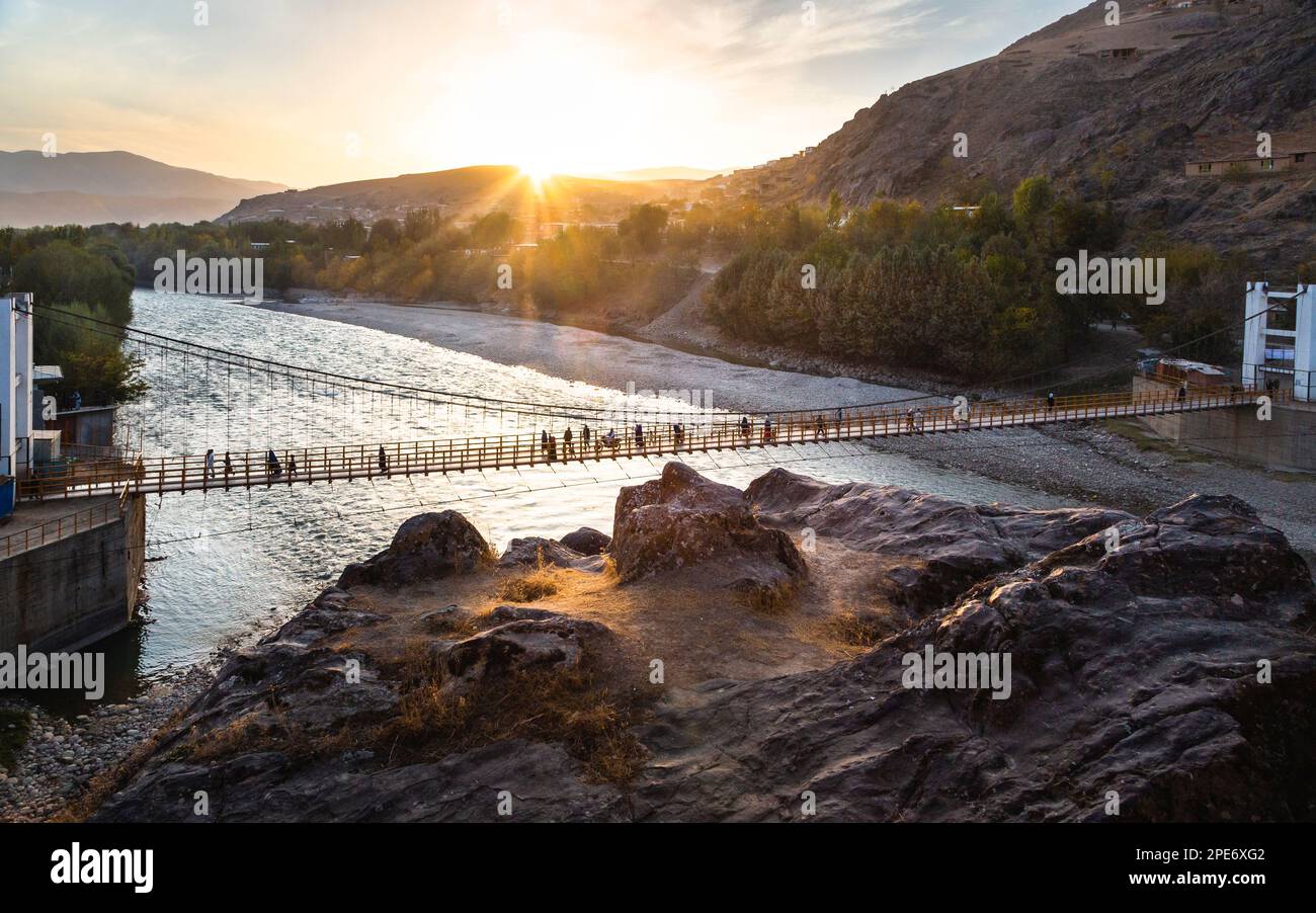 A sunset view of the narrow bridge over Kokcha River in Fayzabad City ...
