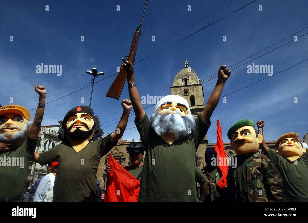 From left to right, Bolivians wearing masks of Cuban President Fidel ...