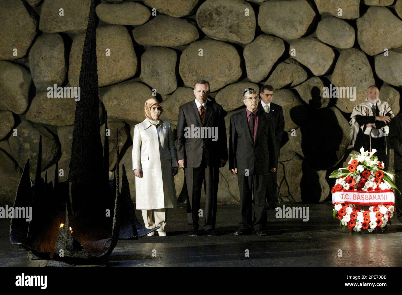 Accompanied by the director of Yad Vashem Avner Shalev, center right ...