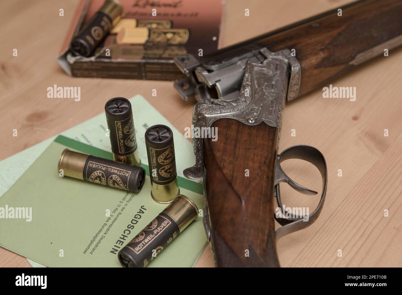 Decorated hunting weapons with ammunition, hunting license and gun ...