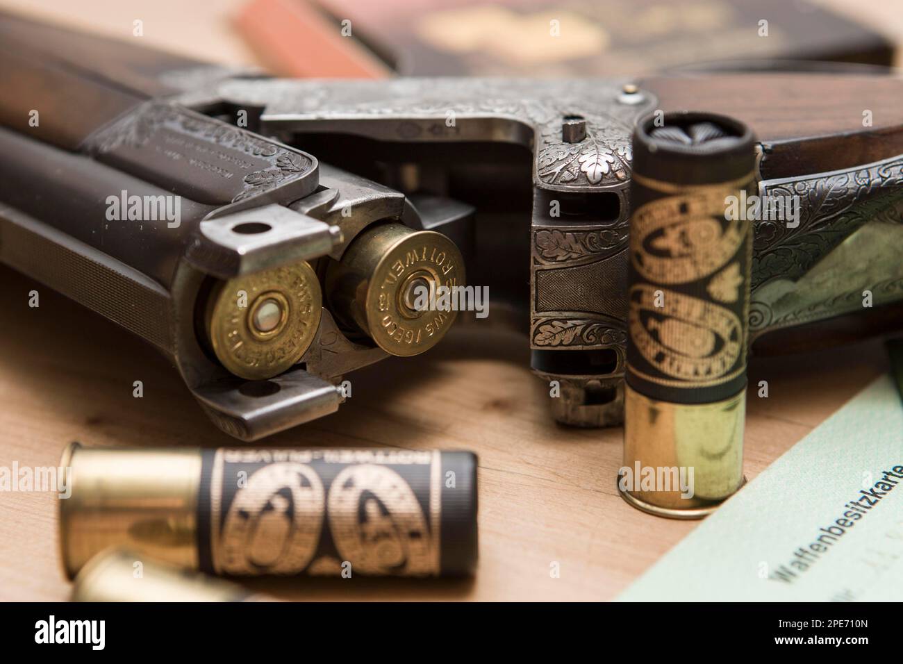 Decorated hunting weapons with ammunition, hunting license and gun ...