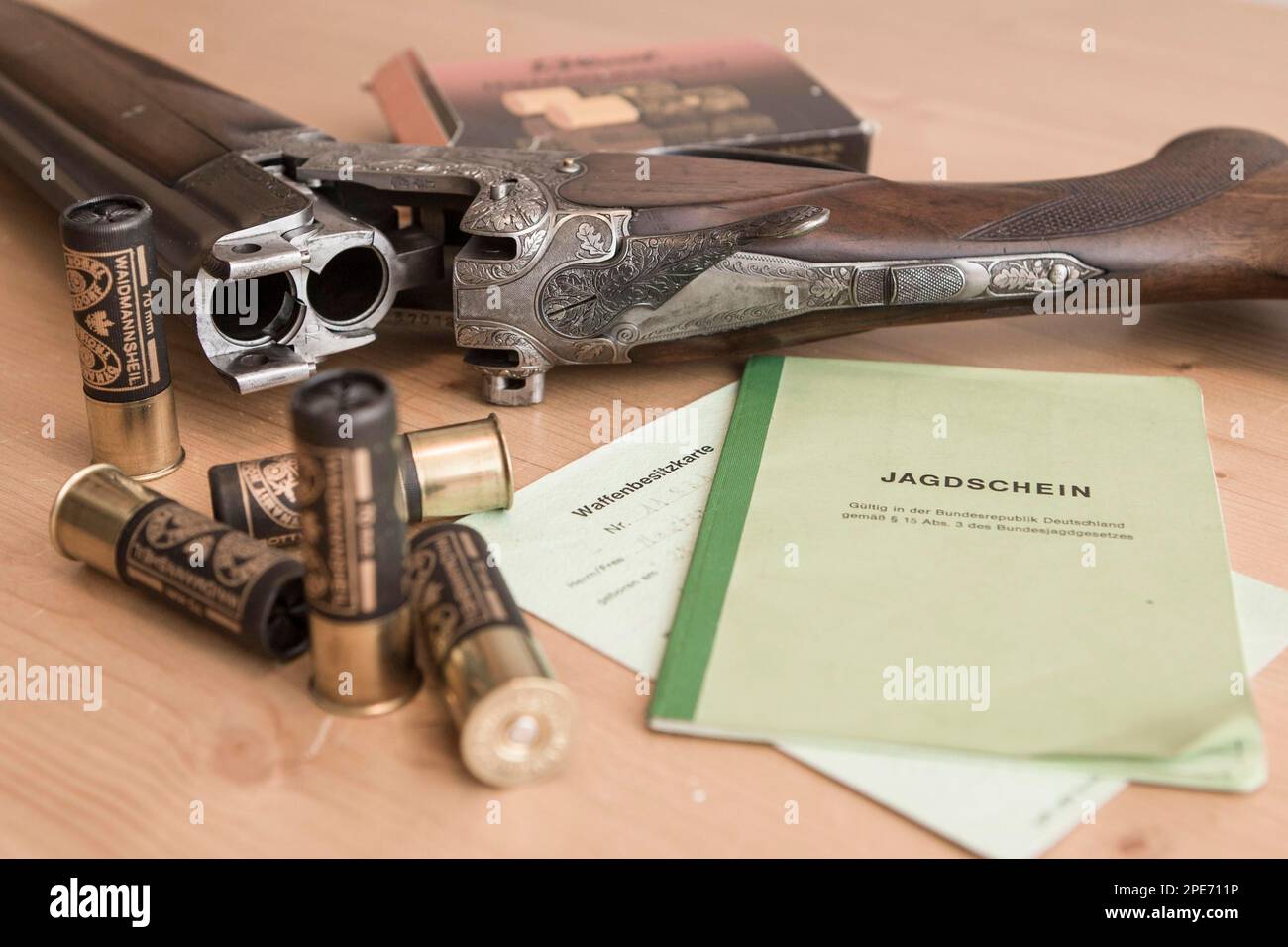 Decorated hunting weapons with ammunition, hunting license and gun ...