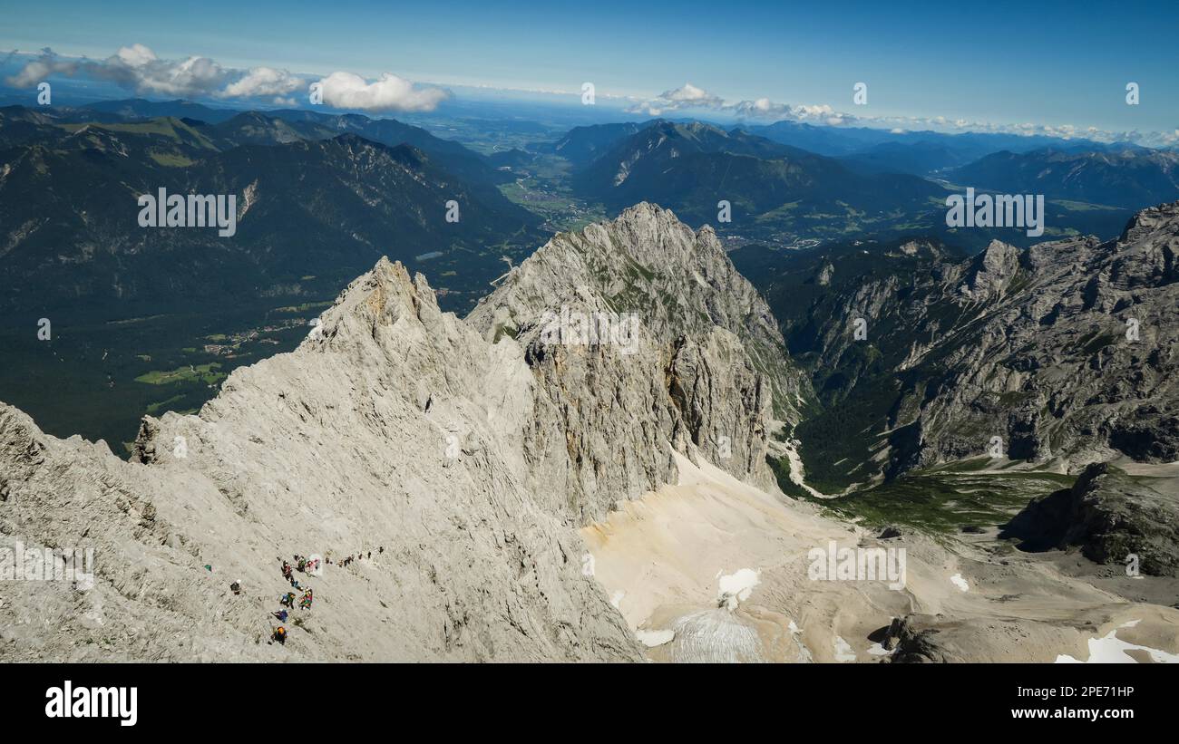 View of the mountain range and tourists entering the via ferrata trail ...