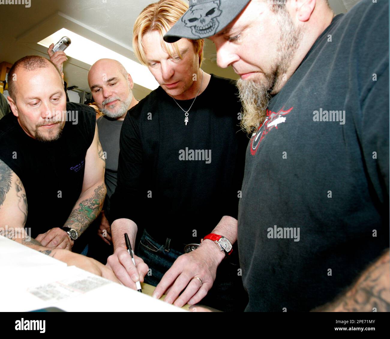 Graphic artists Vince Goodeve, left, Billy Streeter, behind, Keith ...