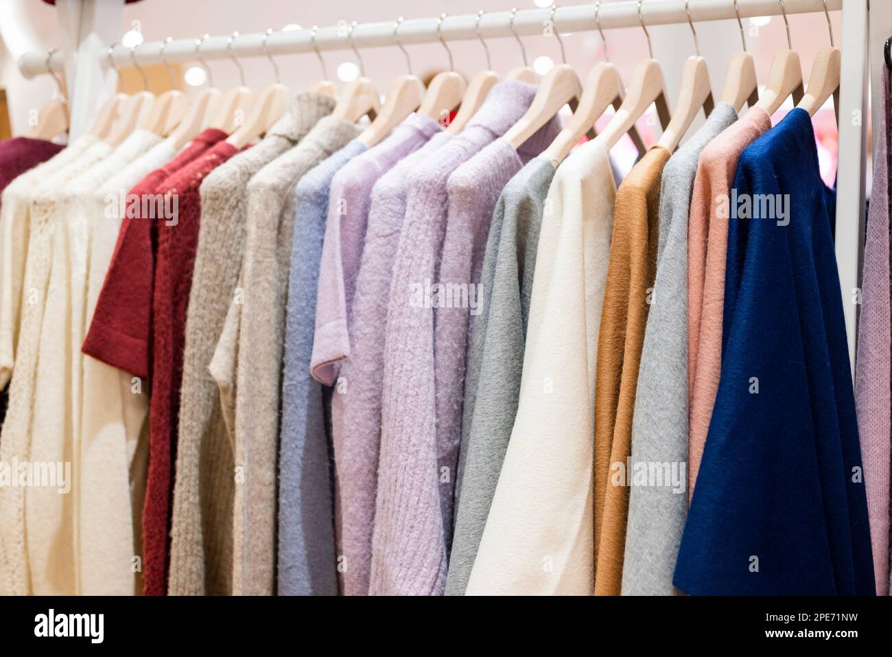 stylish clothes hang on hangers in a store in a mall Stock Photo - Alamy