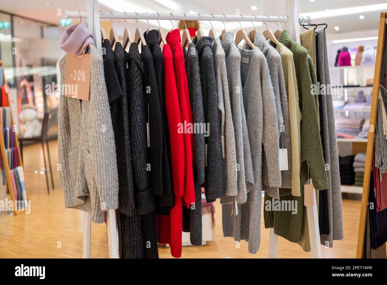 stylish clothes hang on hangers in a store in a mall Stock Photo - Alamy