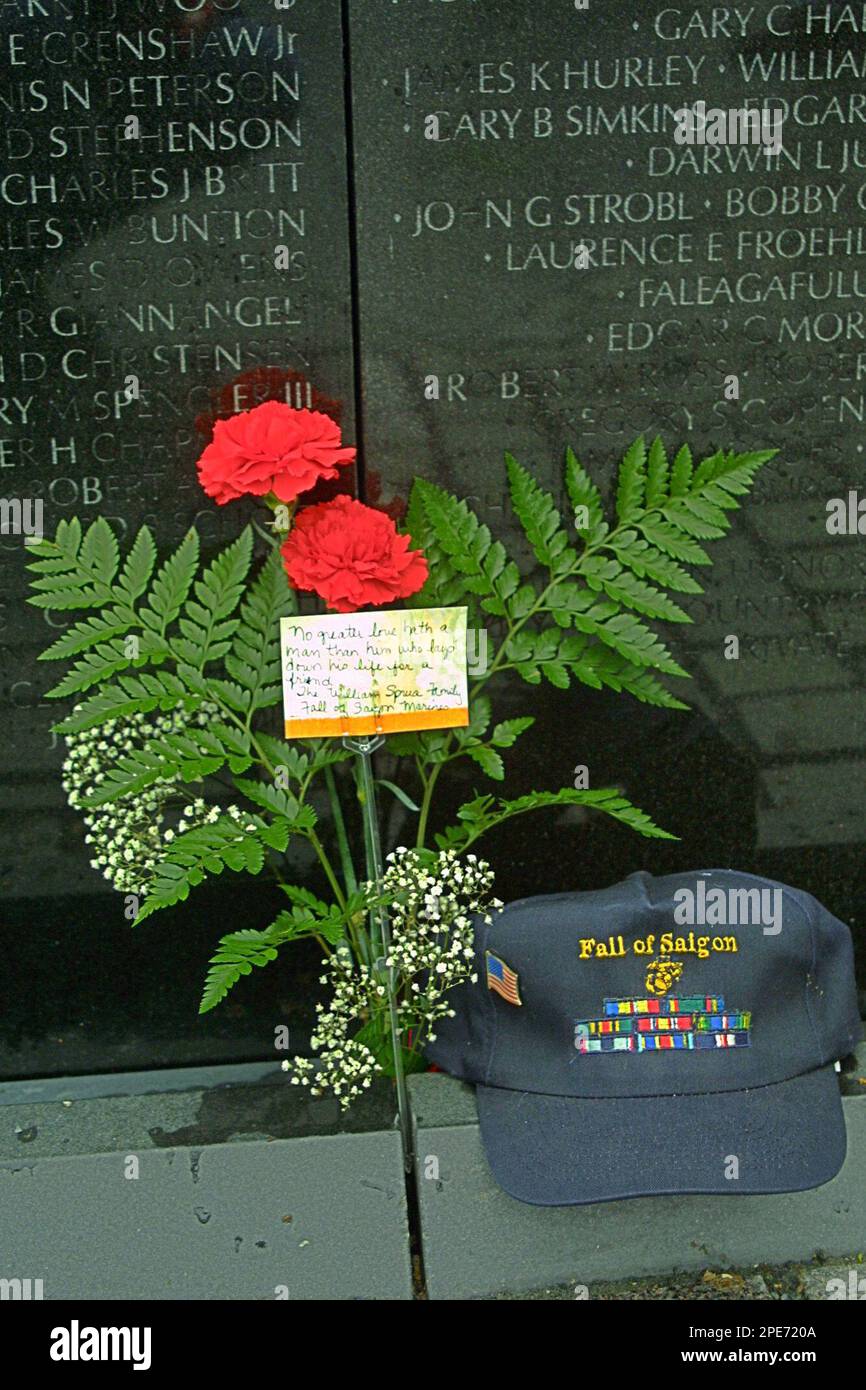 Flowers and a "Fall of Saigon" cap rest at the base of the Vietnam ...