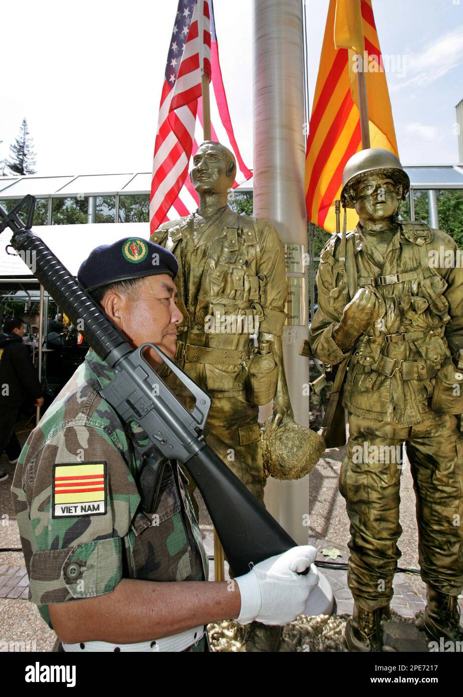 Duong Nguyen, 56, stands in front of a statue of soldiers in Vietnam at ...