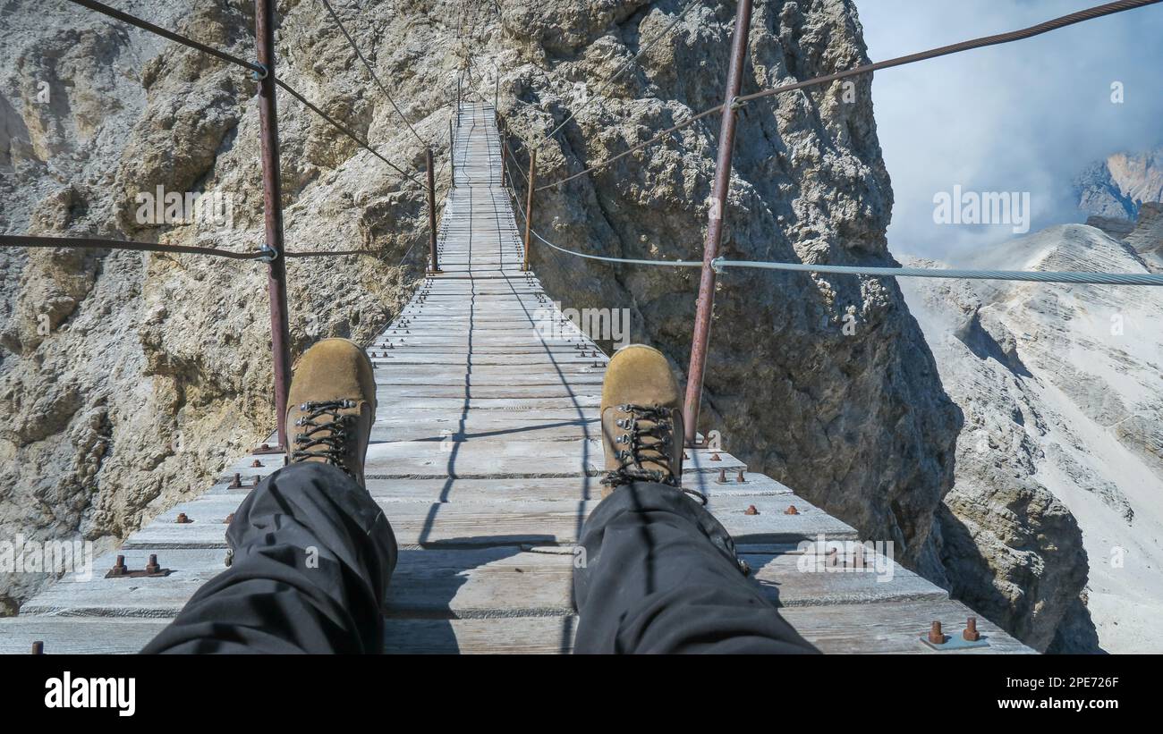 Tourist on the suspension bridge in Monte Cristallo, Dolomite Alps ...