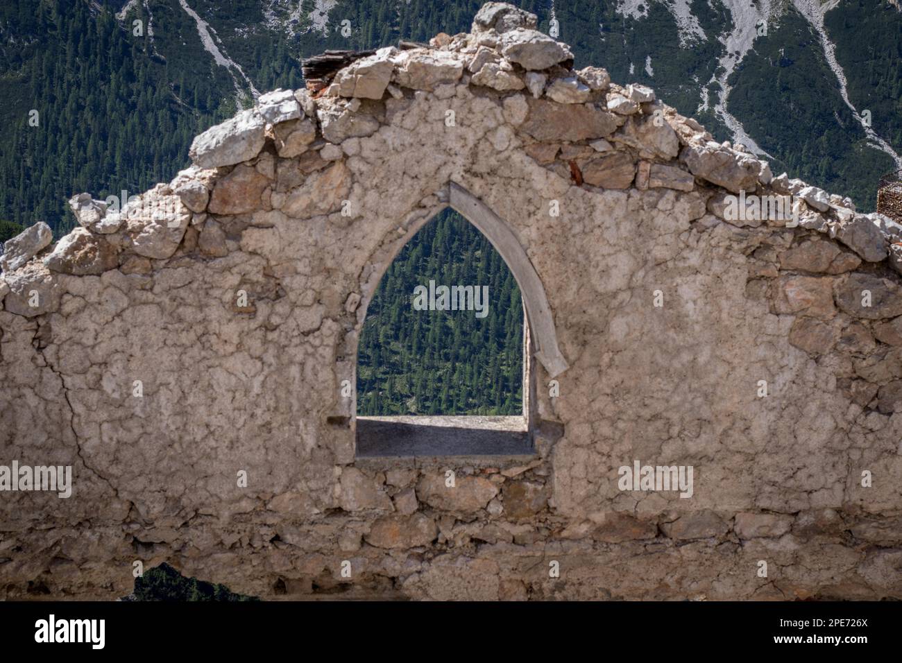 An old, destroyed building standing near the trail in the Dolomites ...