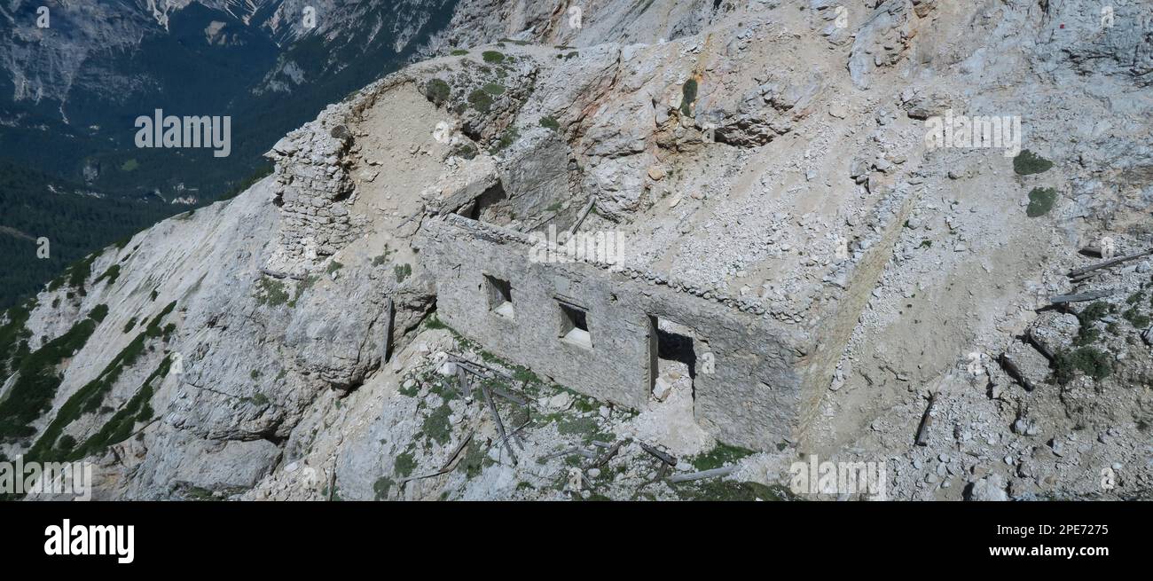 An old, destroyed building standing near the trail in the Dolomites ...