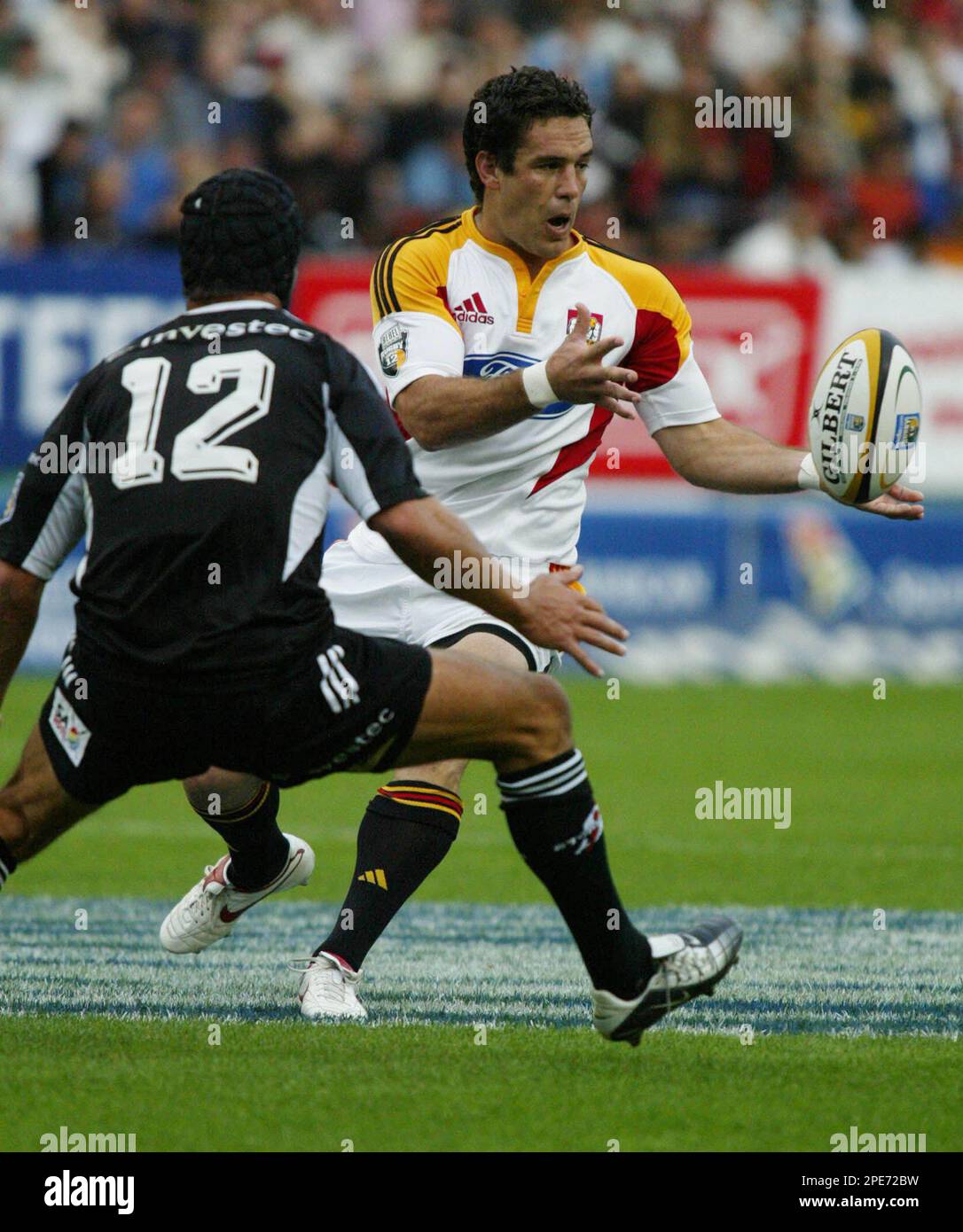 New Zealand Chiefs centre David Hill, right, receives a ball as South ...