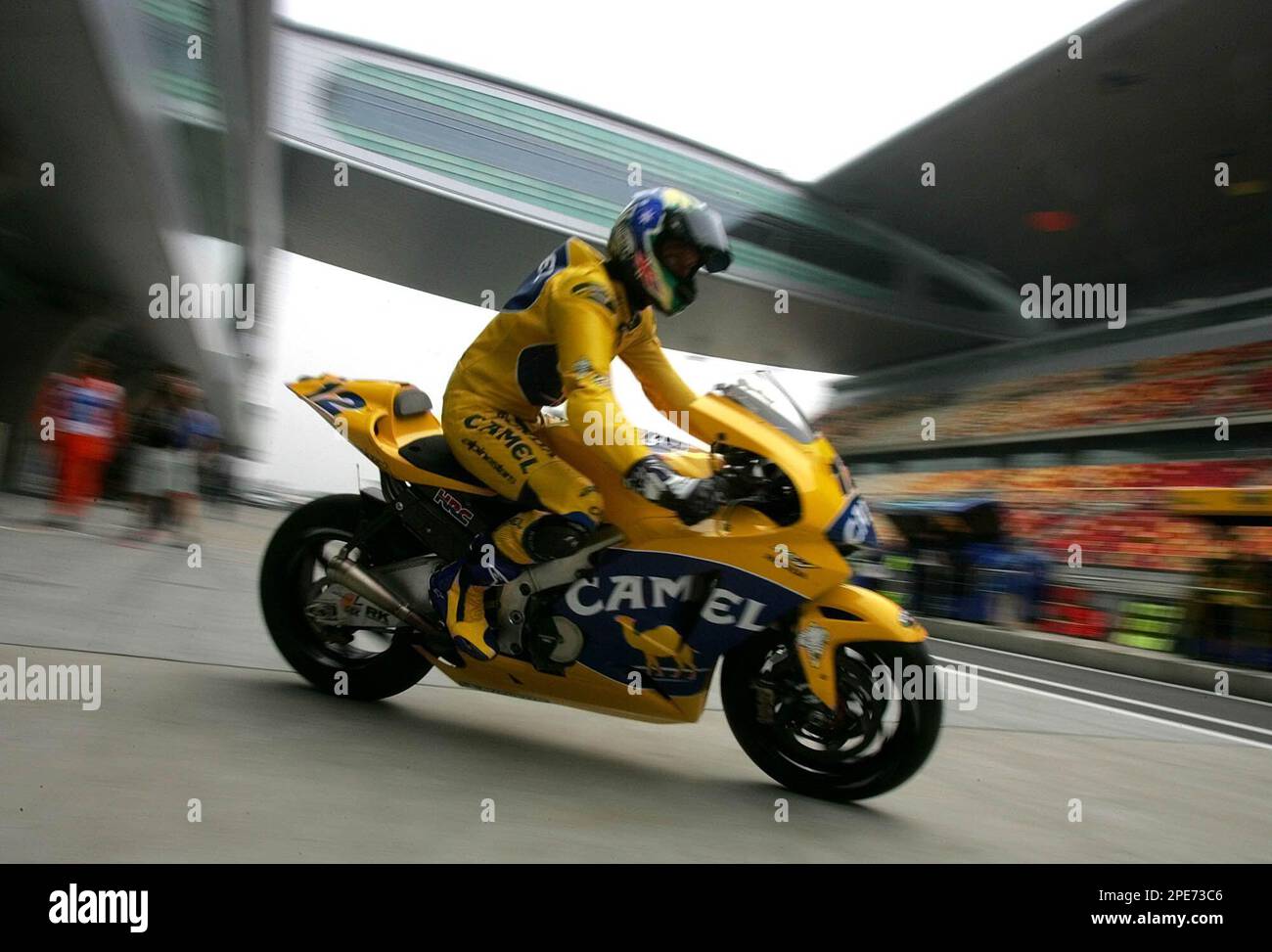 MotoGP rider Troy Bayliss, of Australia, leaves the pits on his Honda ...