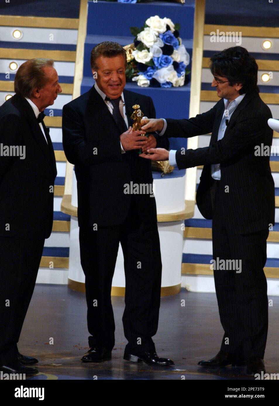 Italian media mogul Vittorio Cecchi Gori, center, receives an award ...