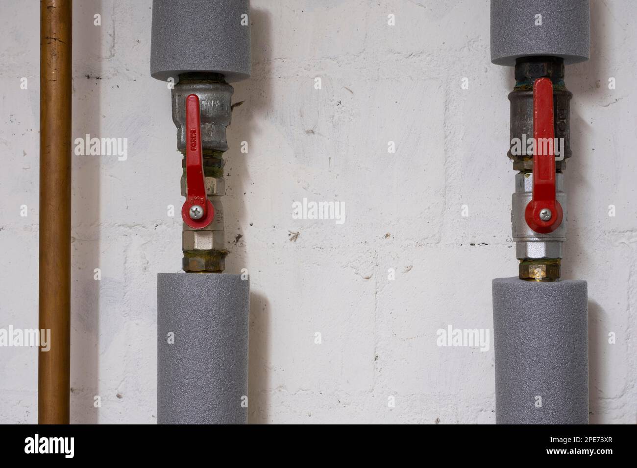 Insulated piping with shut-off valve, next to it a copper pipe, North ...