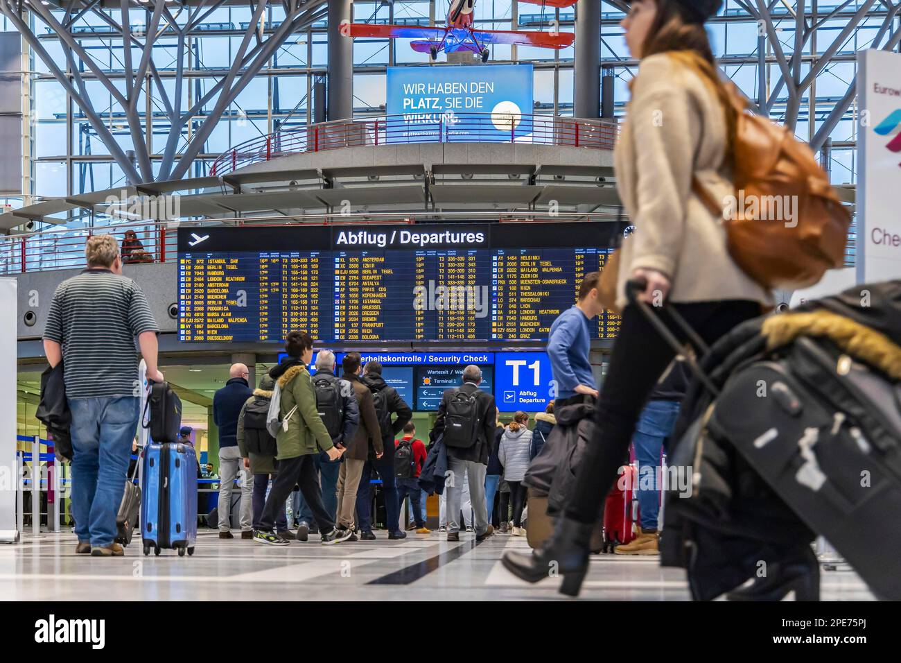 Airport terminal with departure indicator board, departure, travellers ...