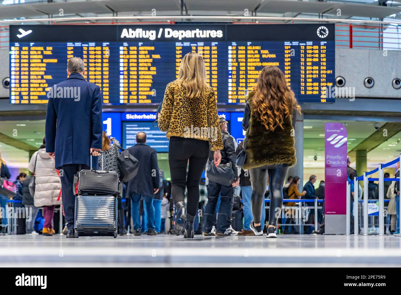 Airport terminal with departure indicator board, departure, travellers ...