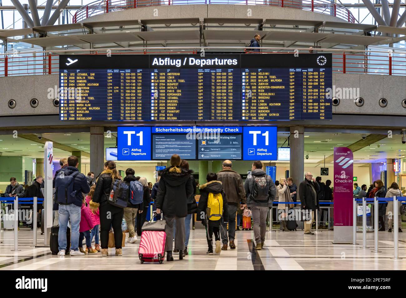 Airport terminal with departure indicator board, departure, travellers ...