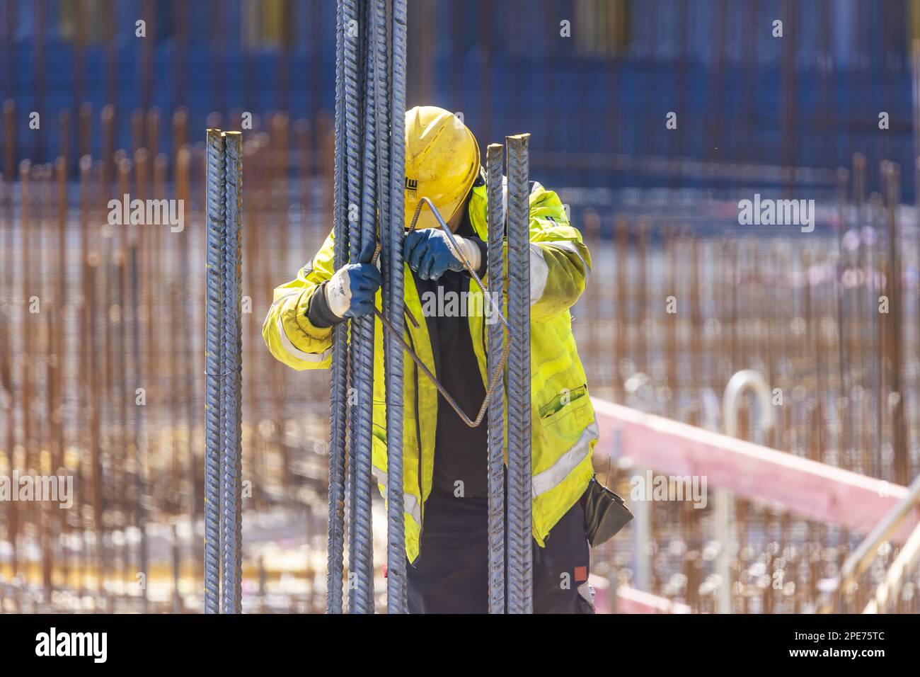 Construction site with construction worker, concrete reinforcement ...