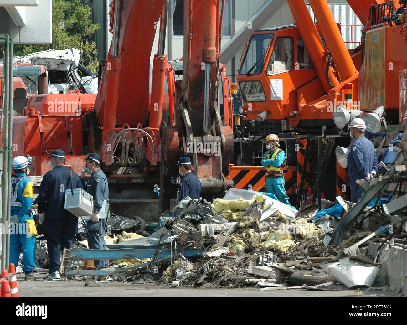 Police investigators examine the wreckage of a derailed train near the ...