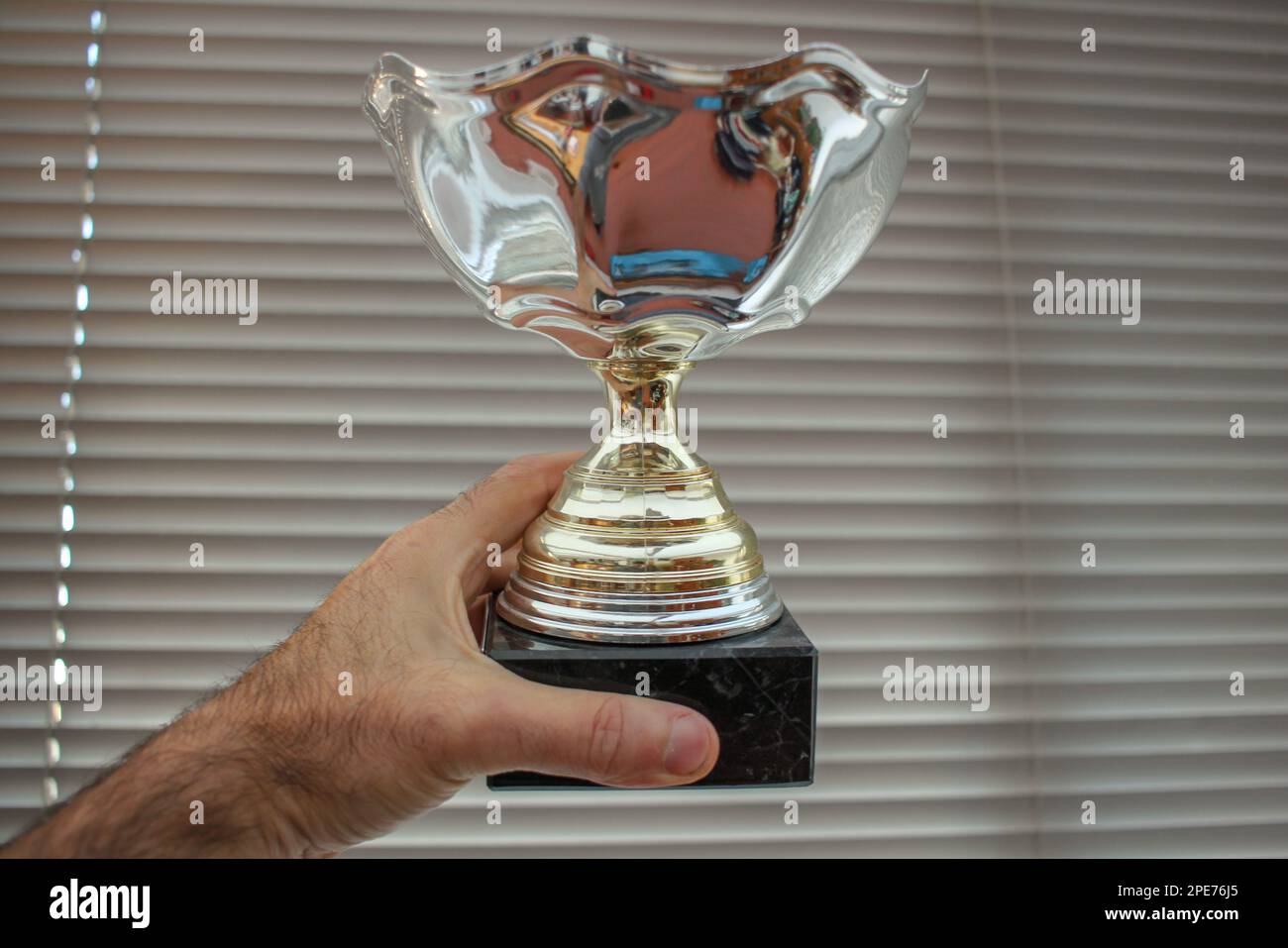 the prize of the winner is a trophy that holds in his hand Stock Photo ...