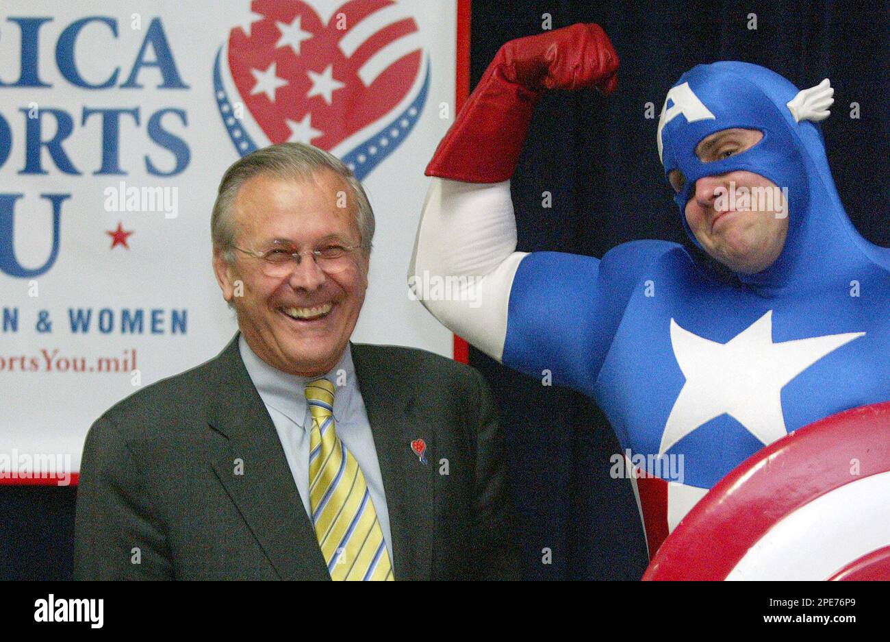 A smiling Defense Secretary Donald H. Rumsfeld, left, pose with a ...