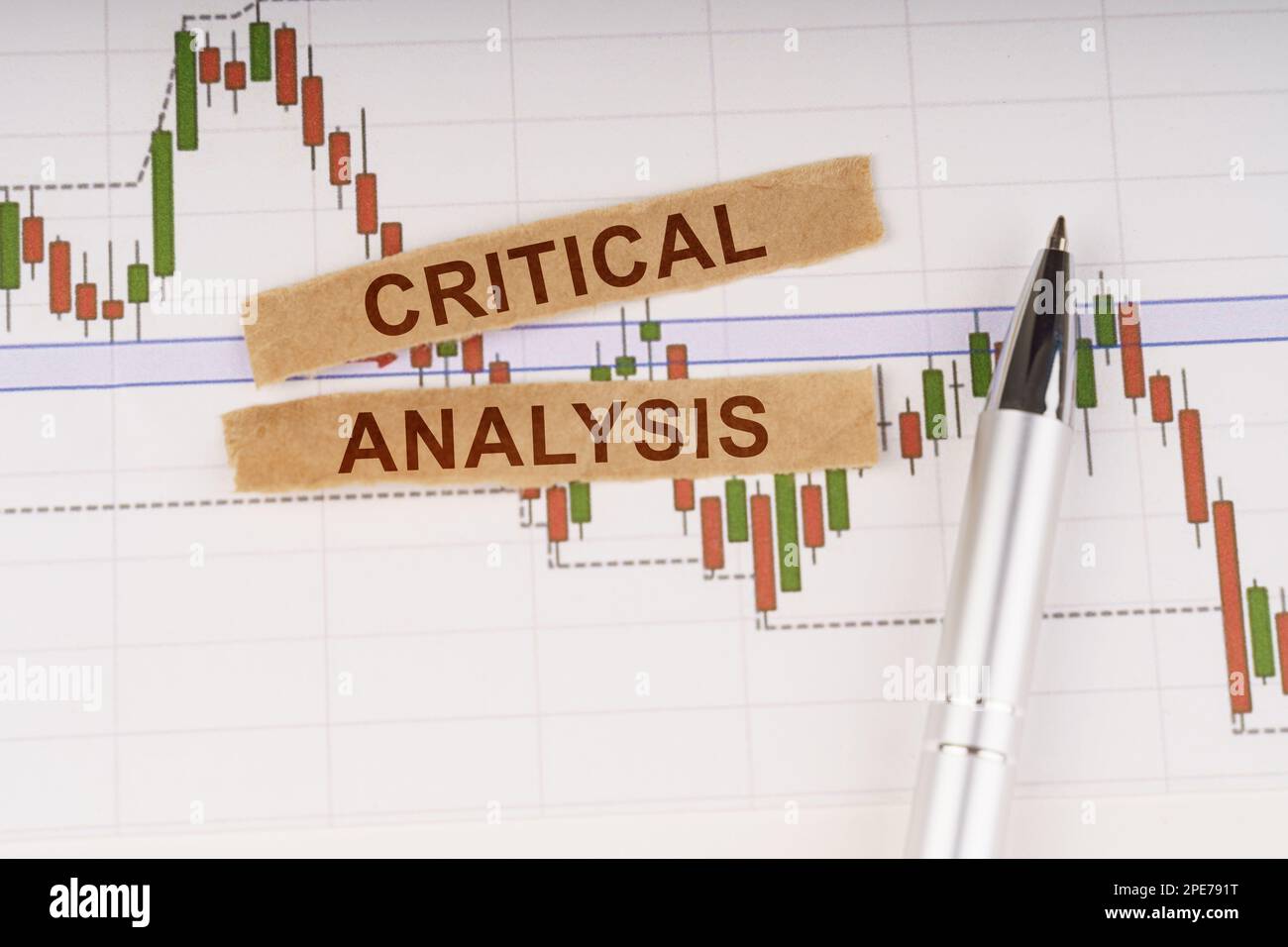 Business concept. On the chart of business quotes lies a pen and torn ...