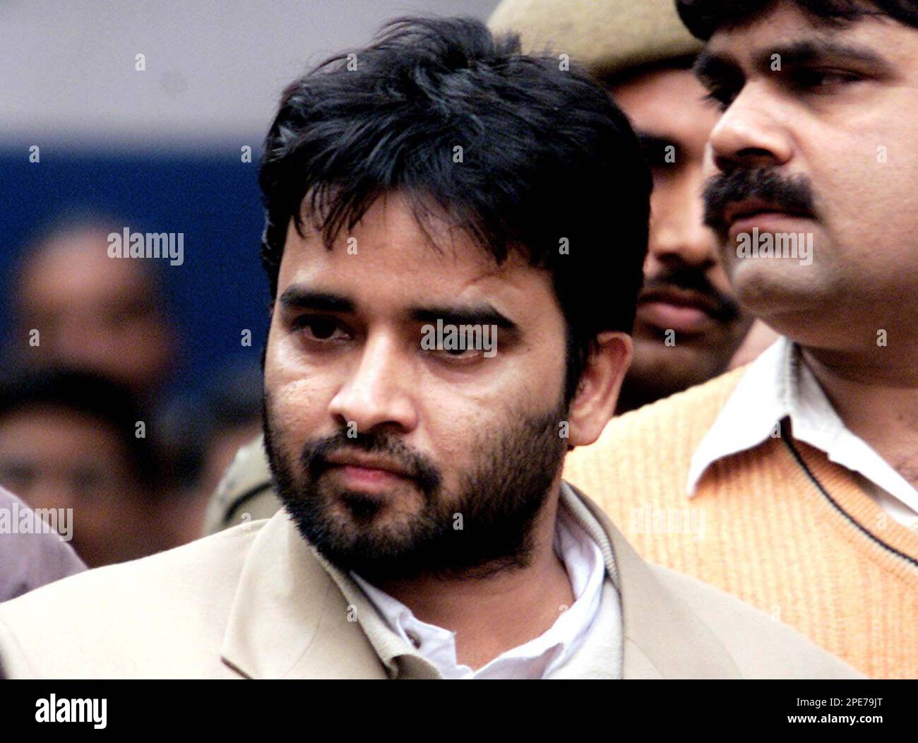 **FILE** Aftab Ansari, also known as Farhan Malik, is escorted by ...