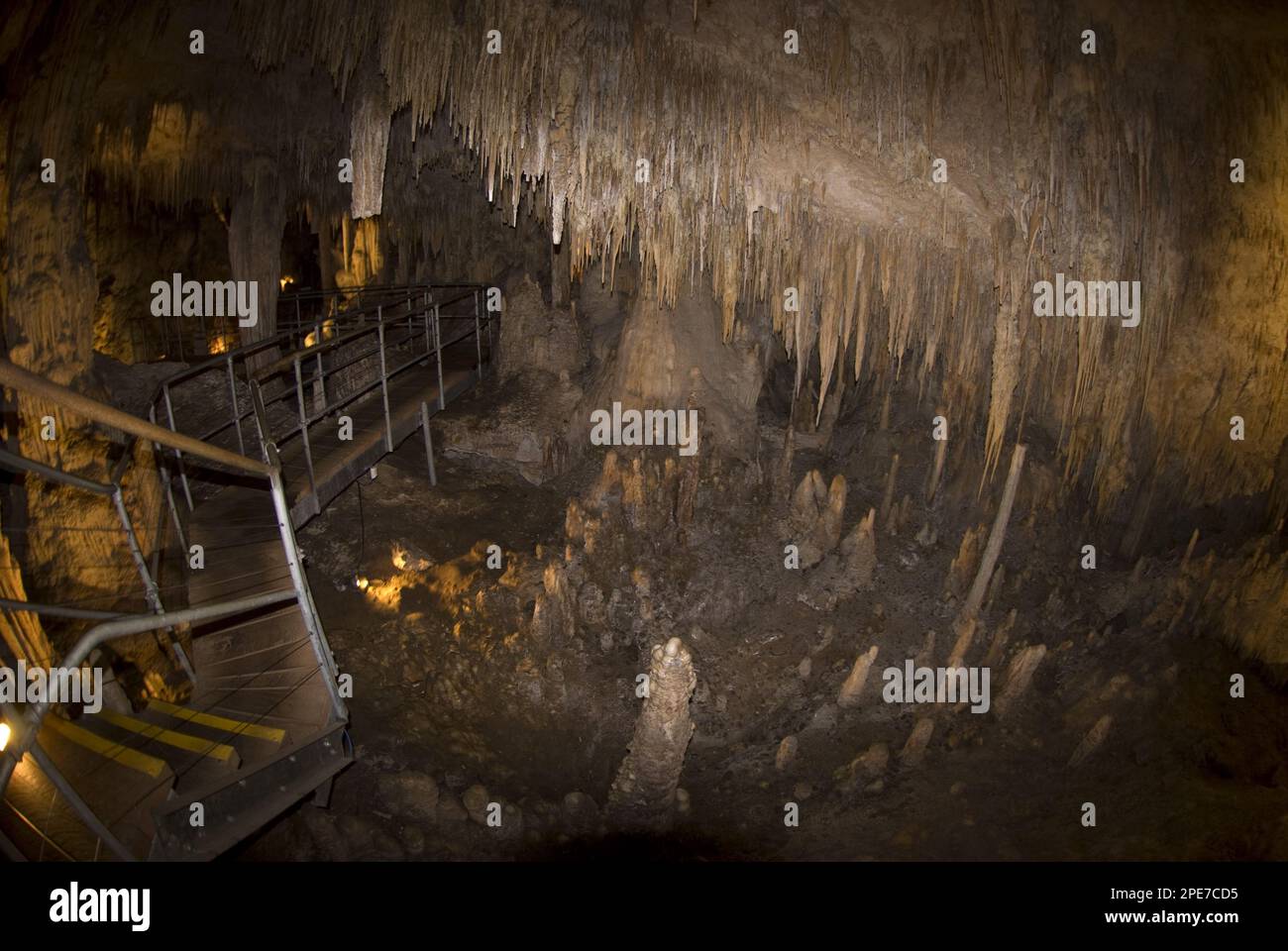 Steps and promenade through a cave with stalactites and stalagmites ...