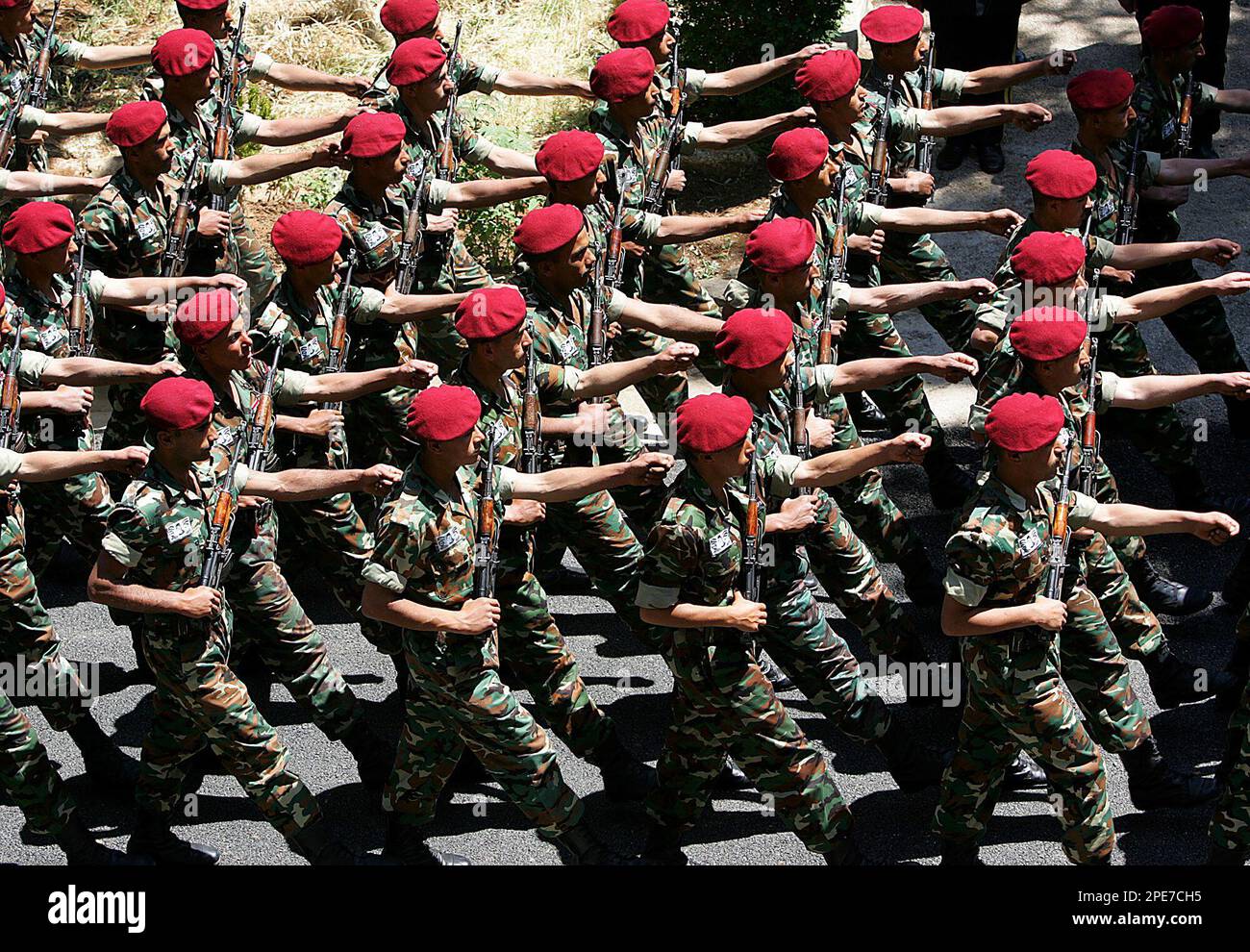 Syrian soldiers parade during a farewell ceremony at the army air base ...