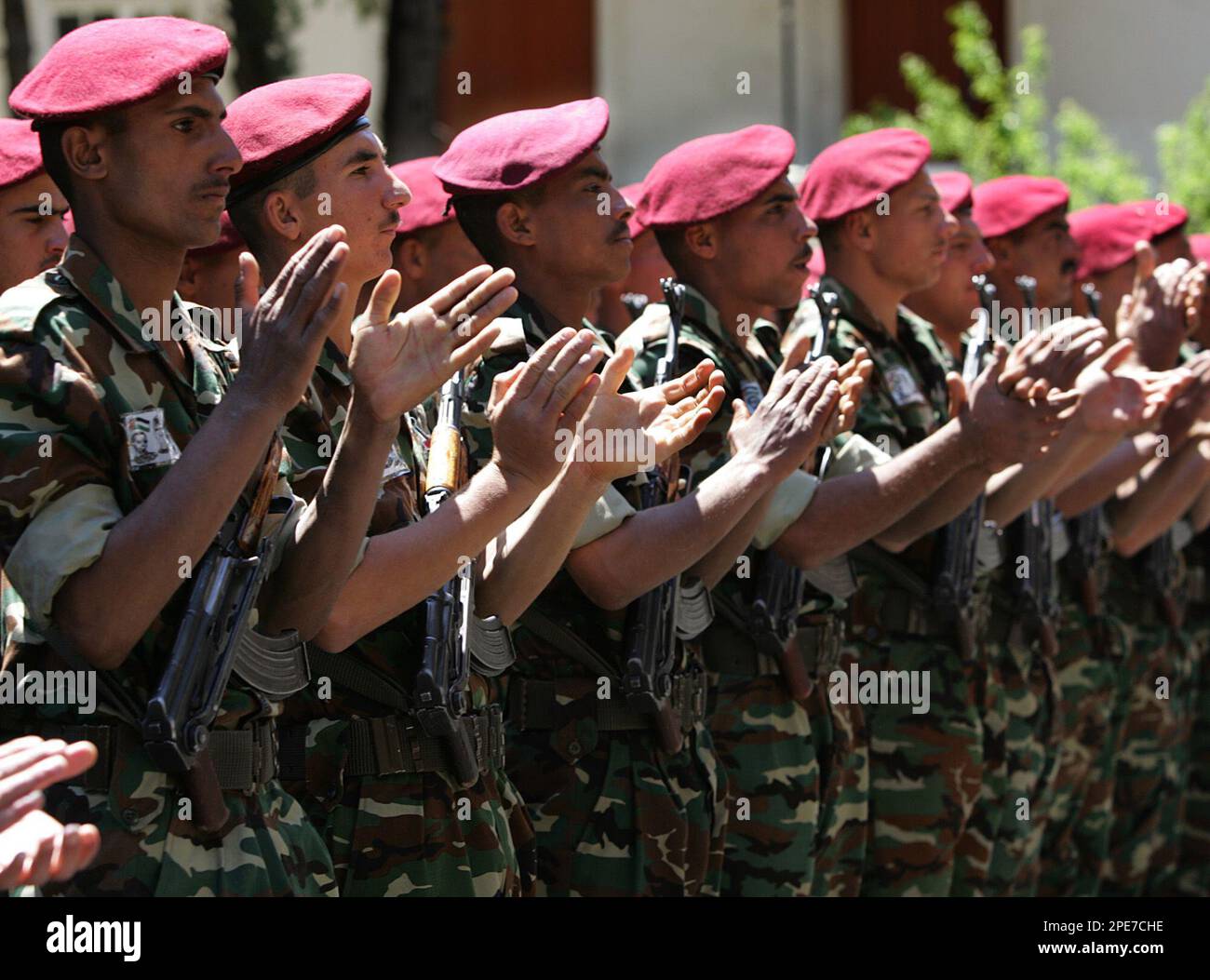 Syrian soldiers applaud during a farewell ceremony at the army air base ...