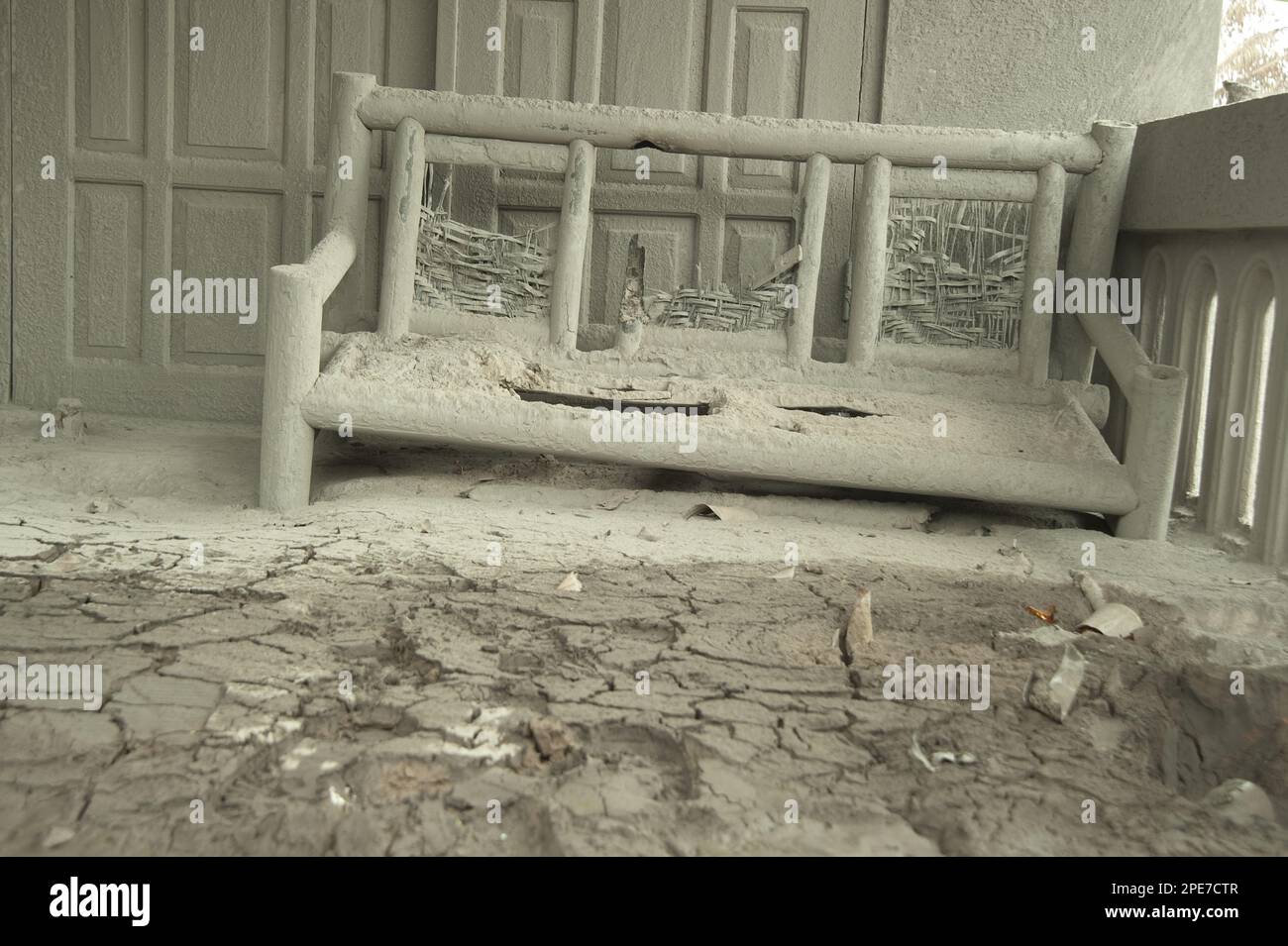 Ash-covered seat outside the house damaged by the recent volcanic ...