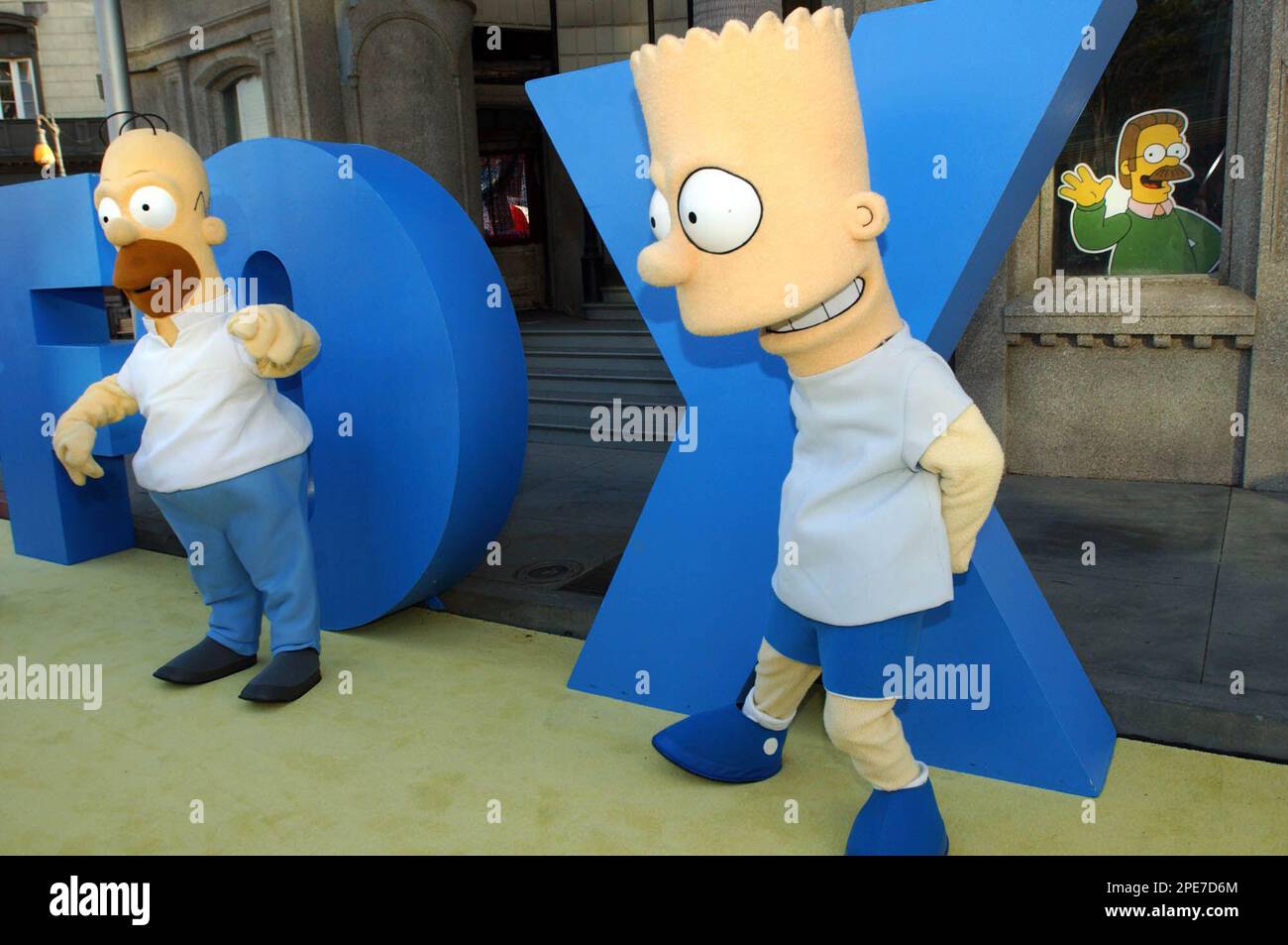 Characters Homer, left, and Bart Simpson pose for photographs during ...