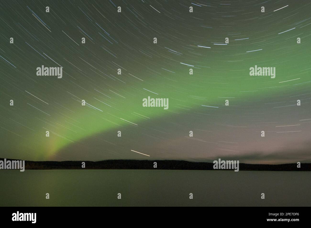 Aurora Borealis and star trails over the lake at night, Muonio, Lapland ...