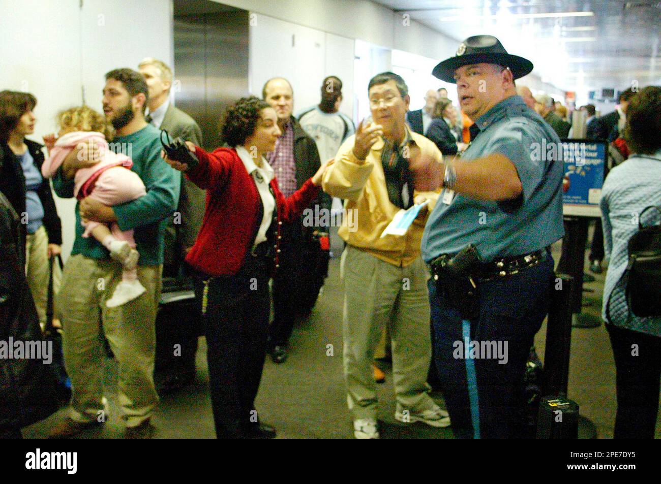 Massachusetts State Trooper James Doucette, right, directs people in a ...