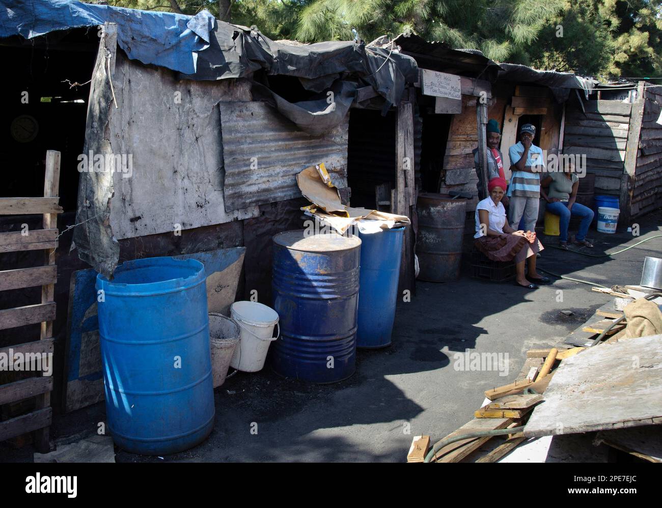 People outside shacks used as housing in Township, Langa Township, Cape ...