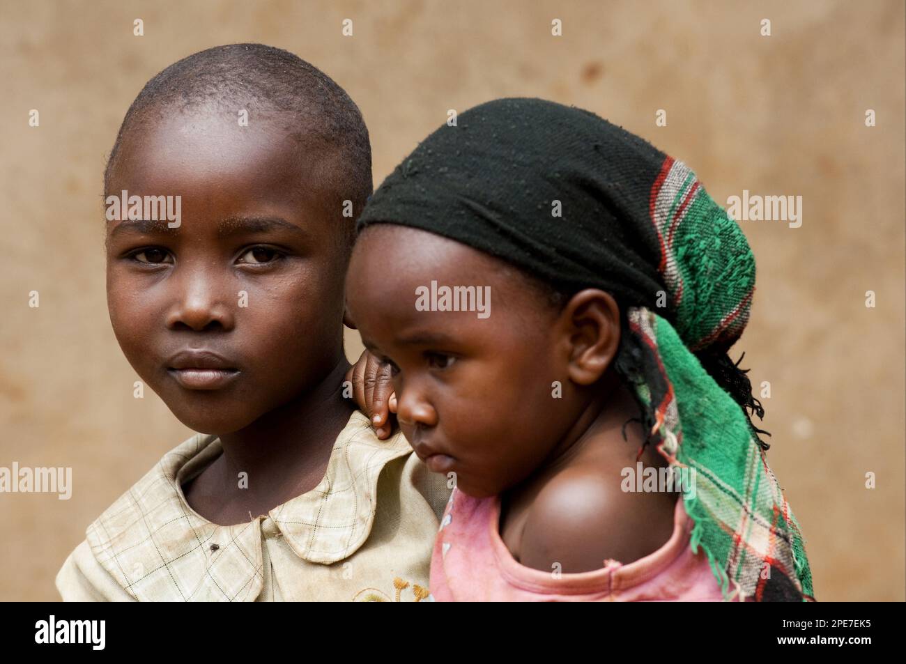 Two sisters, one child carrying the other, close-up of the heads ...