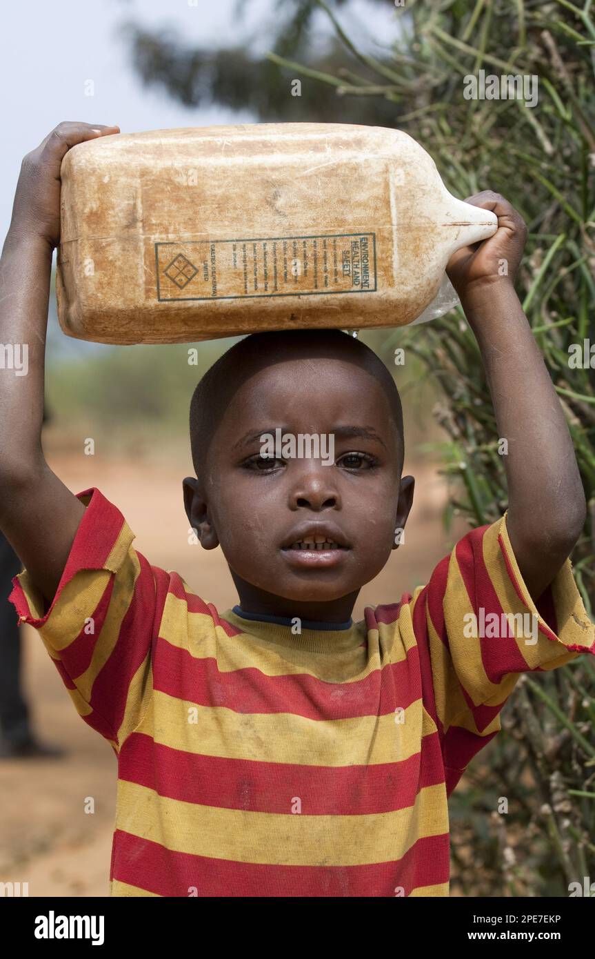 Rwanda woman collecting water hi-res stock photography and images - Alamy
