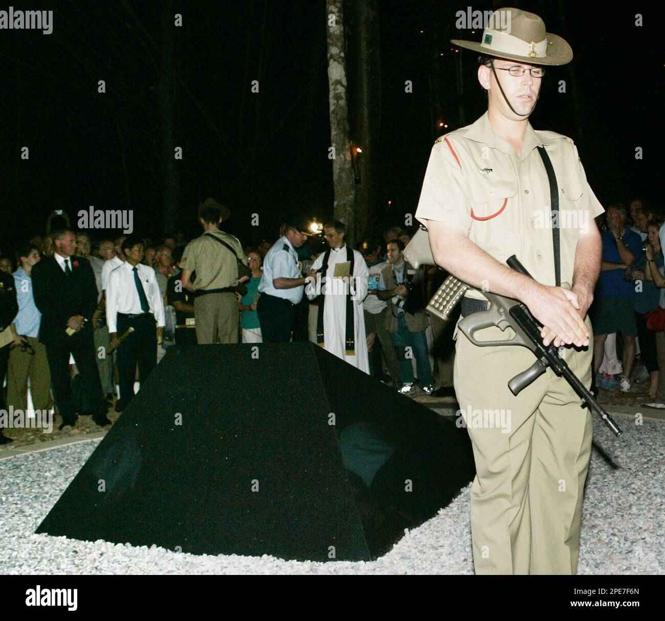 Australia soldier stands in front of a monument during a memorial ...