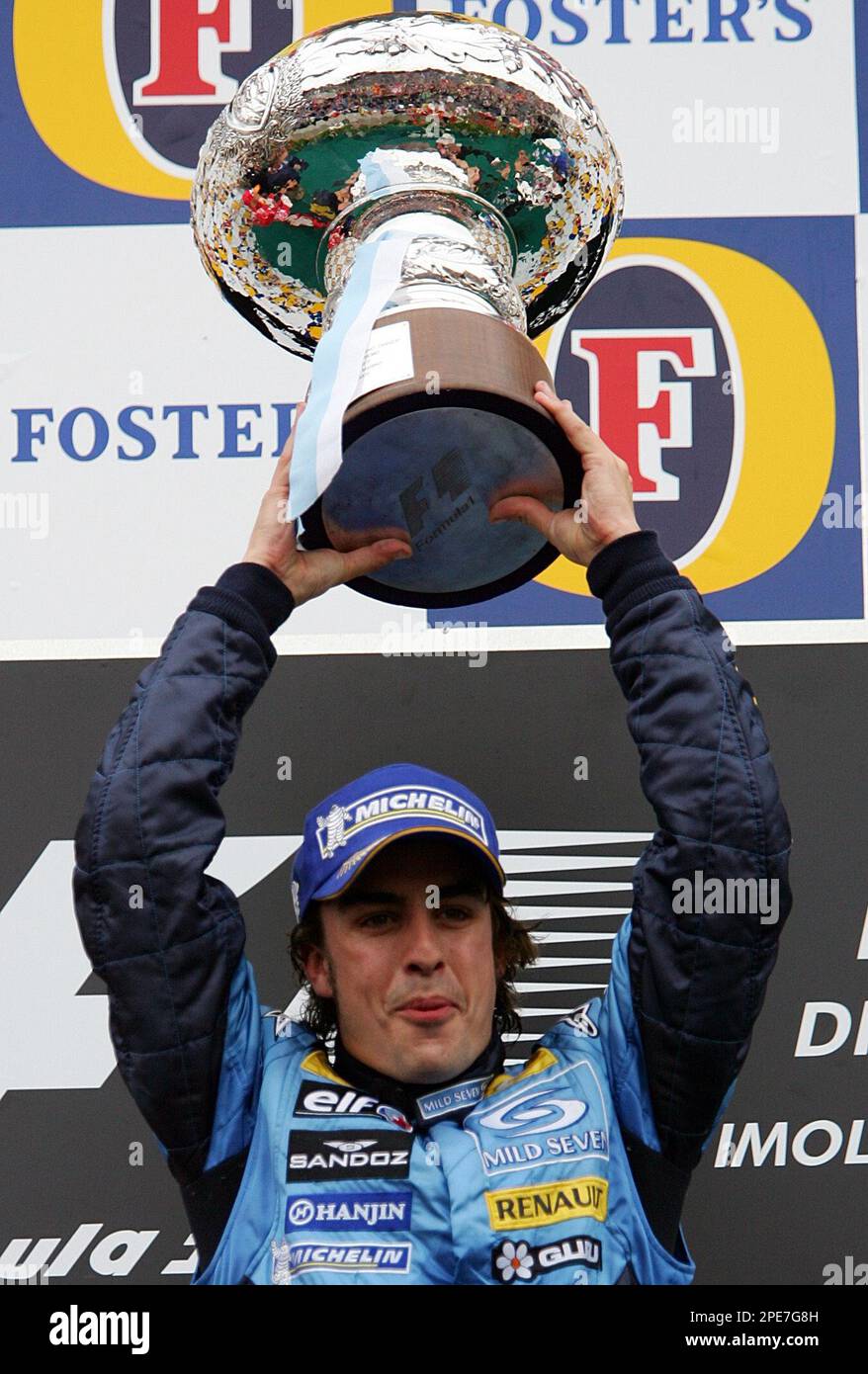Spain's Fernando Alonso shows the trophy he was awarded after winning ...