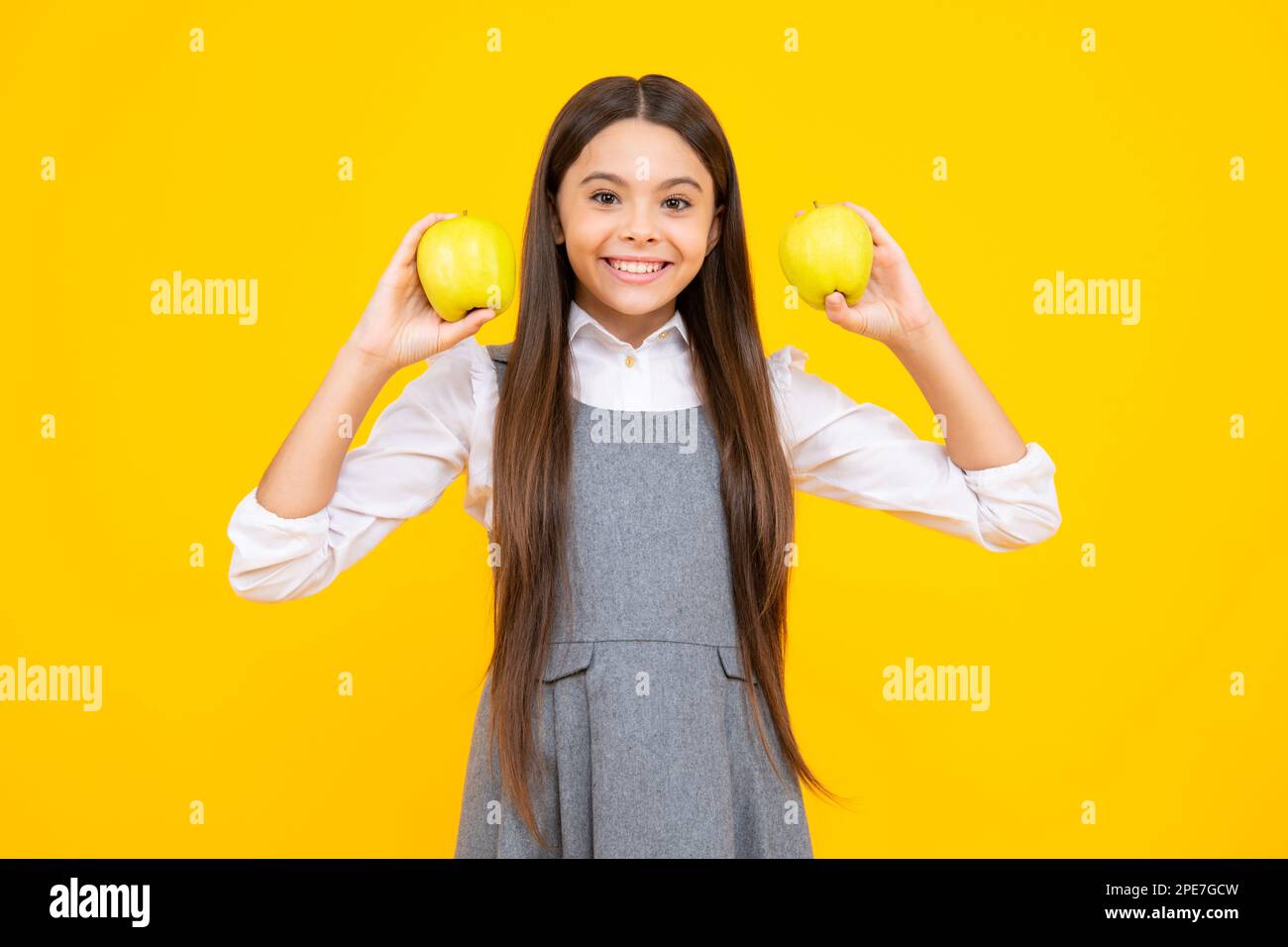 Teenager child with apple on yellow isolated background. apples are ...